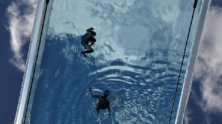 Swimmers float 10-storeys above the ground at London's Sky Pool - CGTN