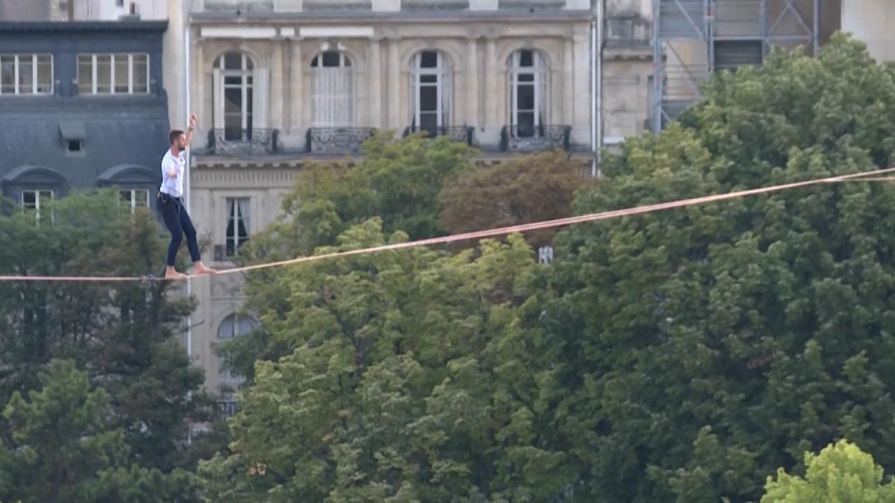 French world record breaking acrobat crosses the Seine on a high-wire ...