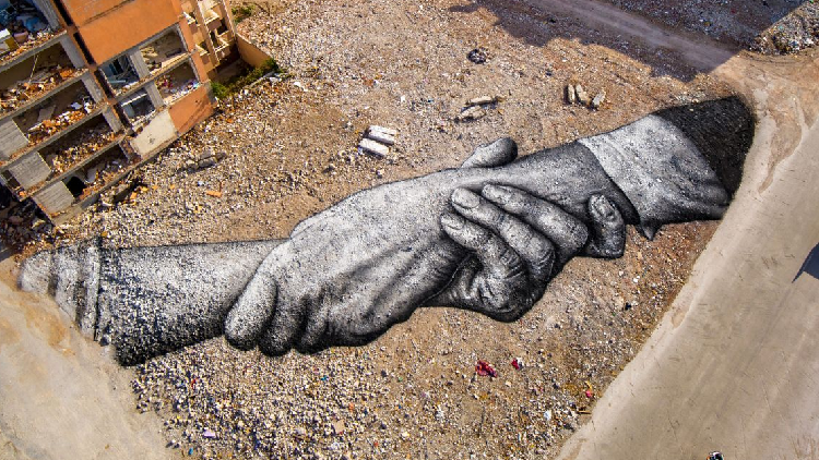 Artist creates huge mural on rubble of earthquake-hit Turkish city - CGTN